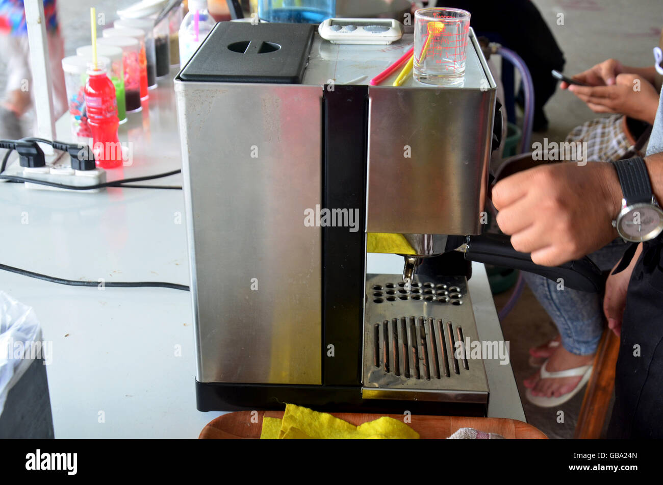 Thai people cooking hot coffee with mini coffee machine at coffeeshop ...