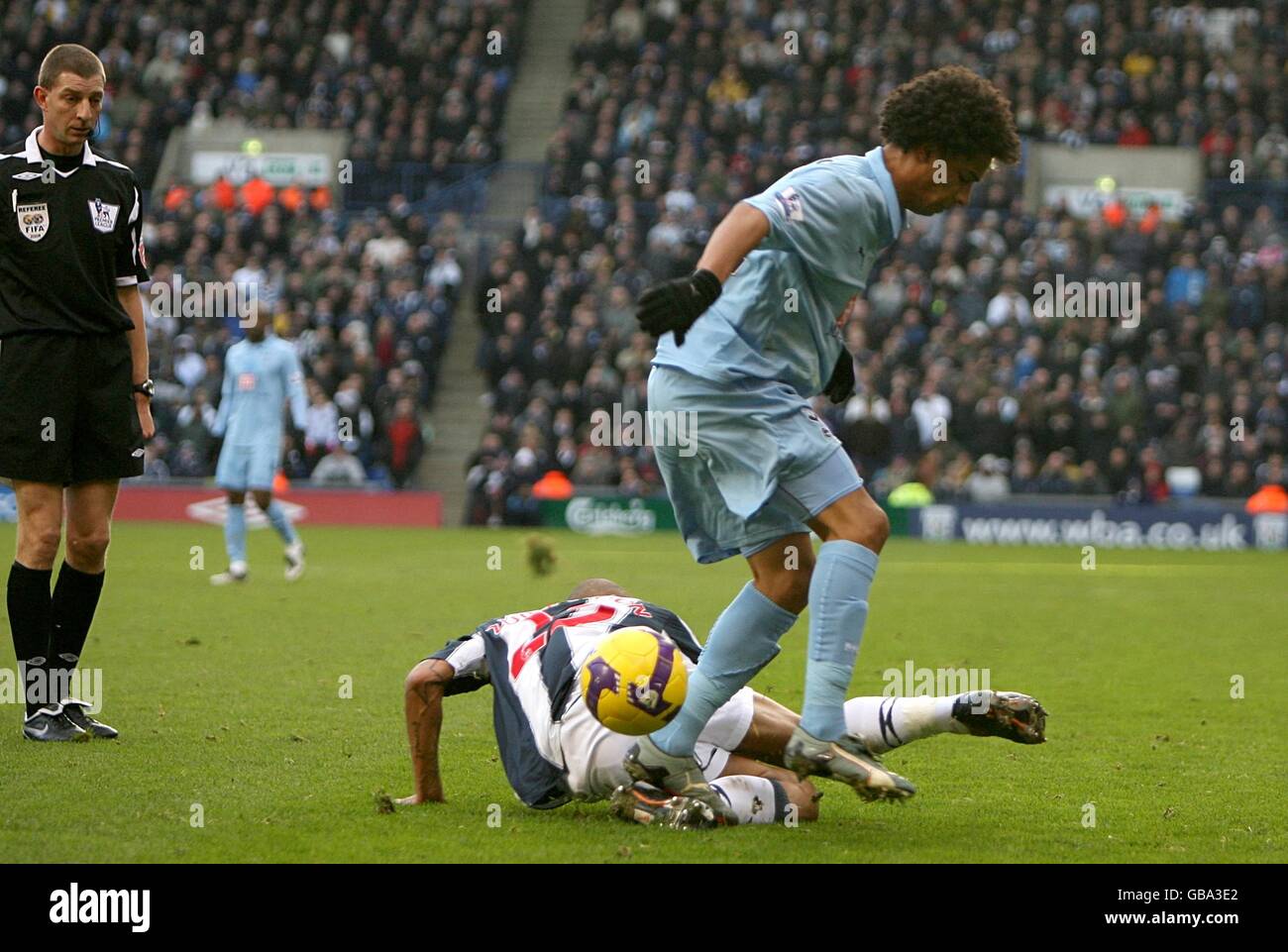 Referee Steve Tanner (l) looks on as Tottenham Hotspur's Benoit Assou ...