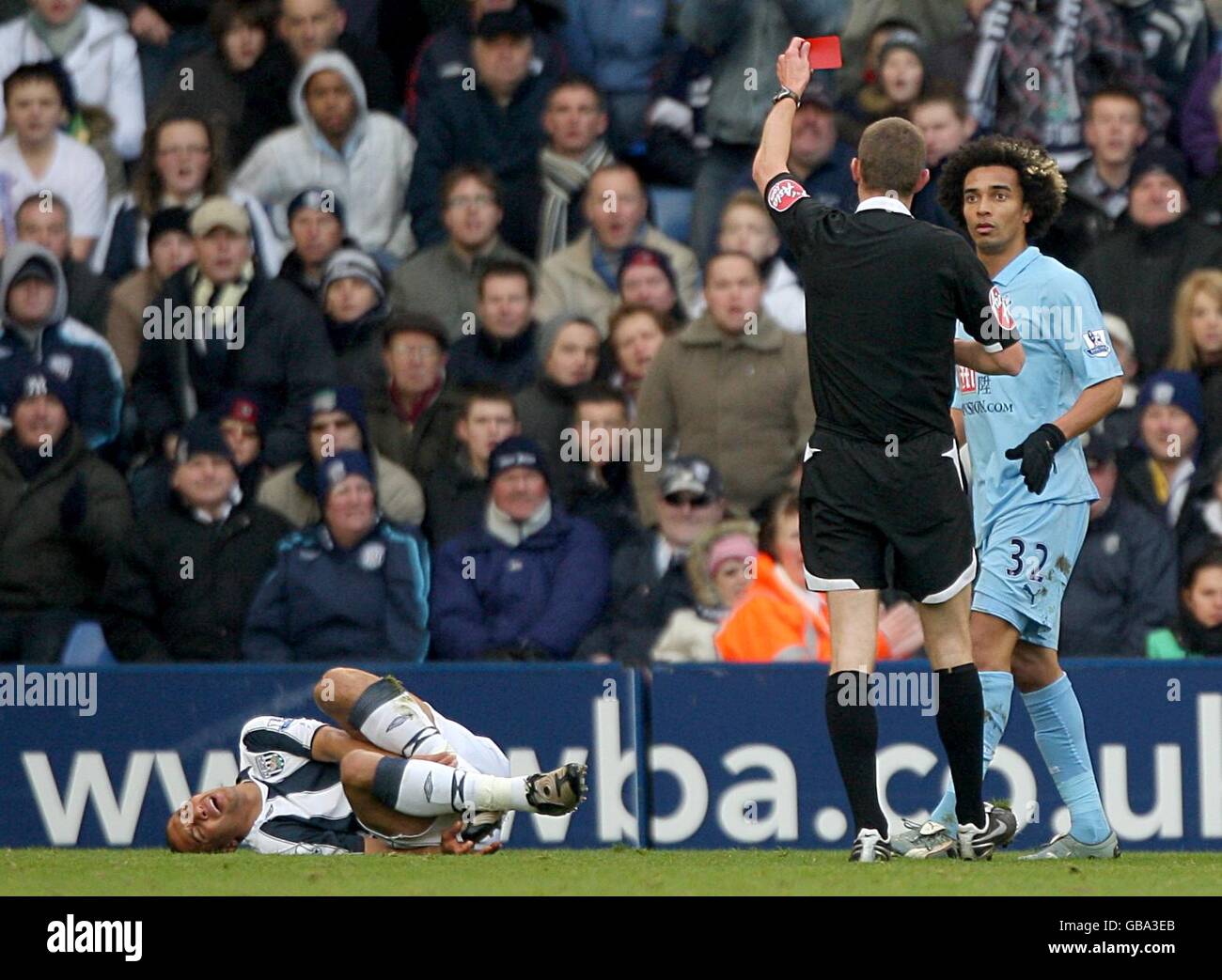 Tottenham Hotspur's Benoit Assou-Ekotto is shown a red card by referee ...