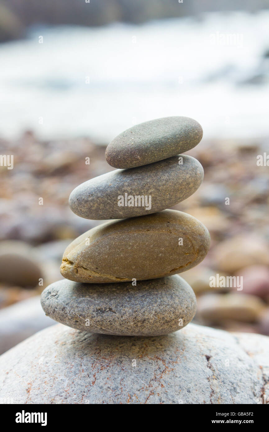 Colored stones set in balance on a beach Stock Photo - Alamy