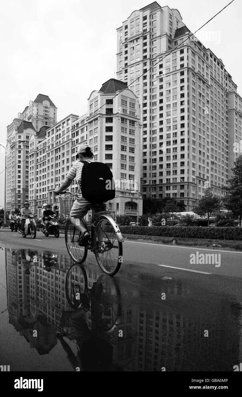 HO CHI MINH, VIET NAM- DEC 15: Young boy ride bicycle on street with ...