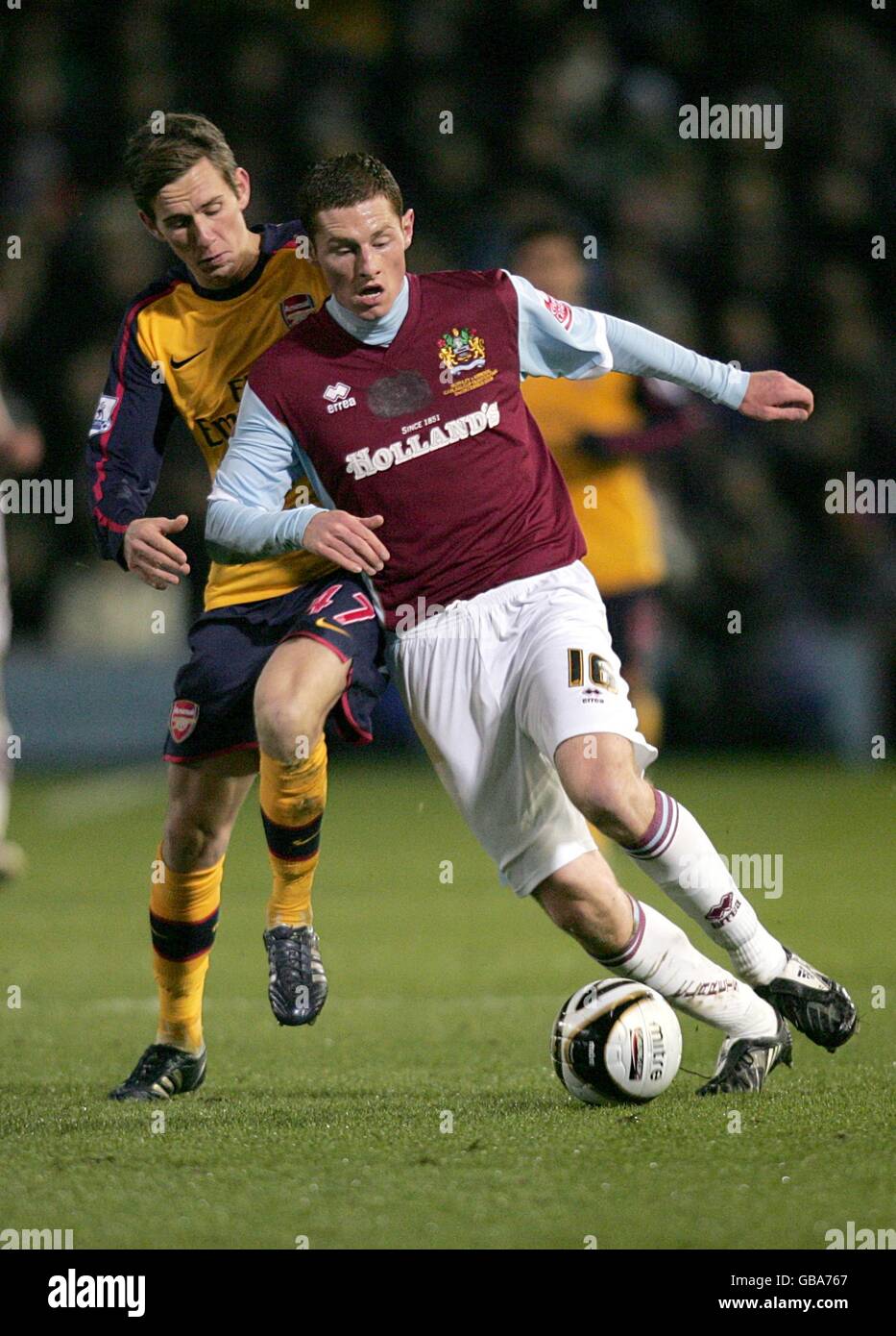 Burnley's Chris McCann (r) is challenged by Arsenal's Mark Randall for ...