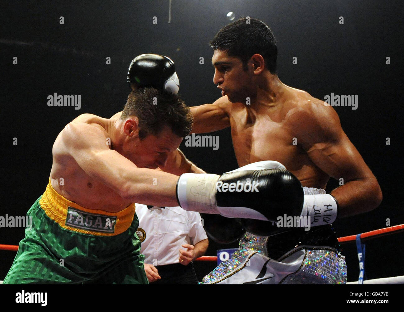 Irishman Oisin Fagan left takes a shot from Great Britain's Amir Khan ...