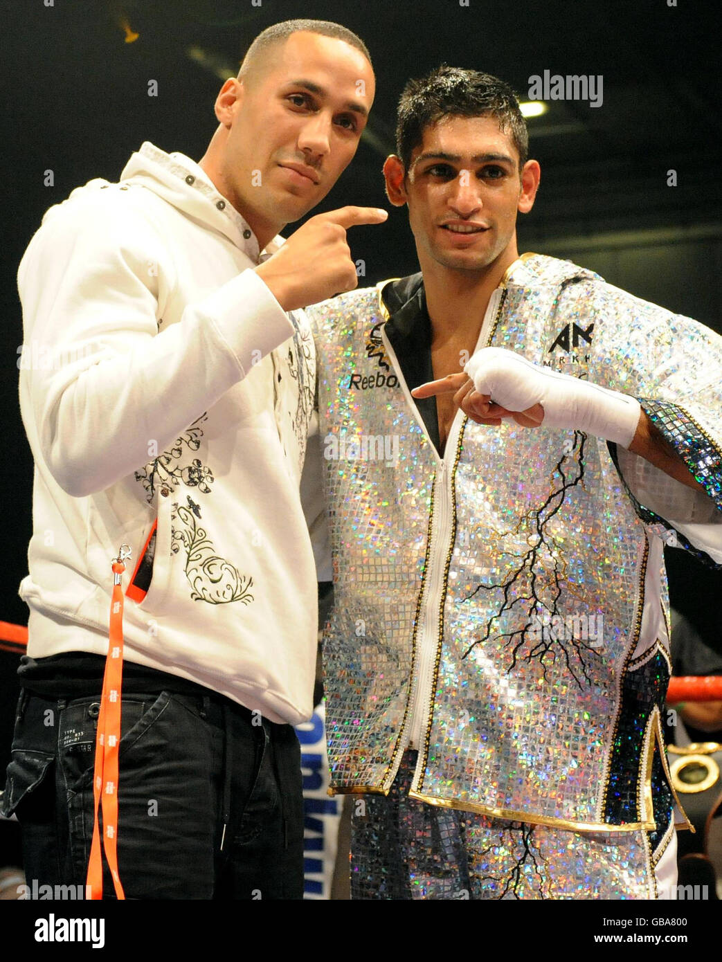 Great Britain's Amir Khan (right) is joined in the ring by former ...