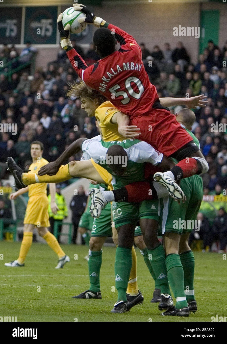 Hibernian goalkeeper Yves Ma-Kalambay rises above Celtic defender Glenn ...