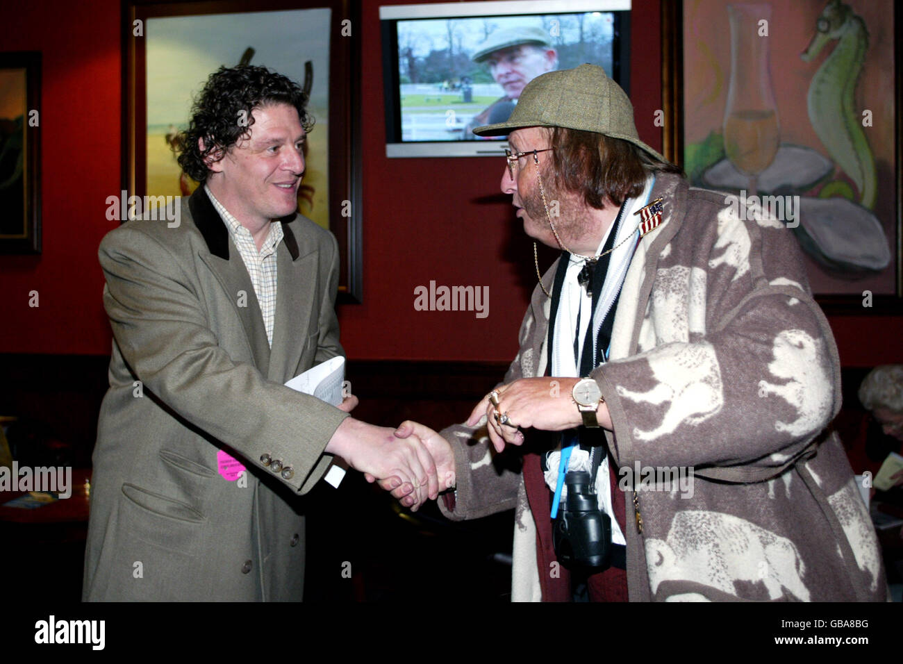 Racing pundit John McCririck (r) shakes hands with chef Marco Pierre ...