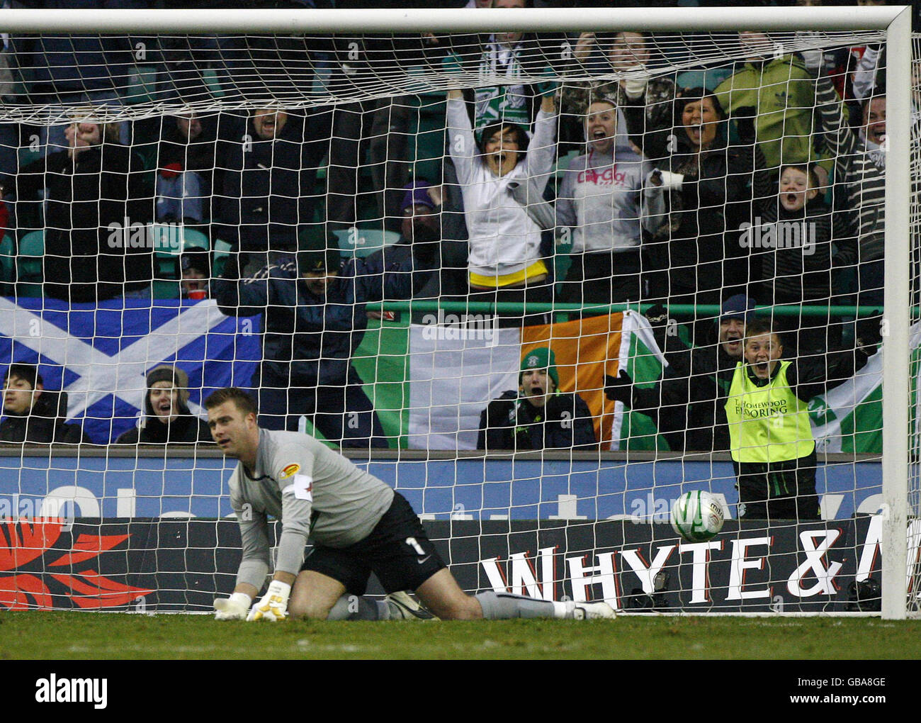 Celtic goalkeeper Artur Boruc on his knees after he misjudges a shot by Hibernian's John Rankin ...