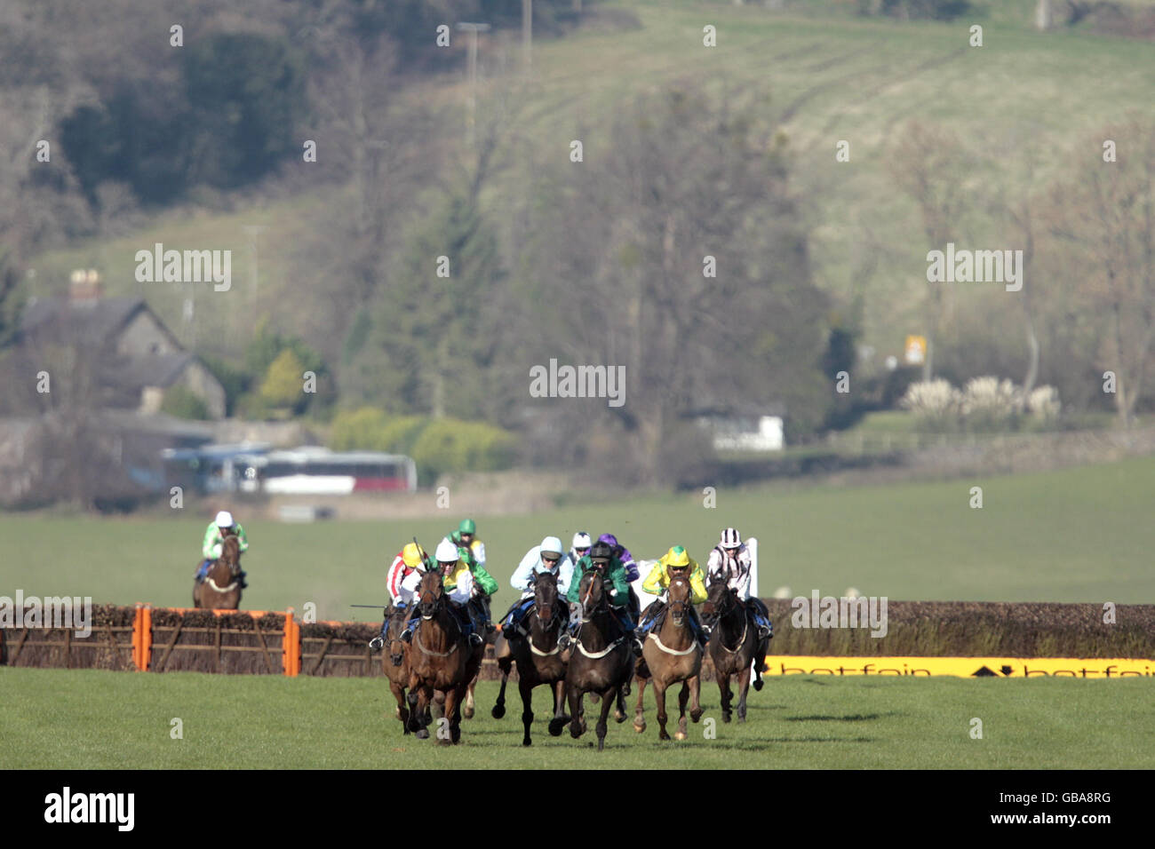 Horse Racing - Chepstow Racecourse. Horses and riders make their way ...