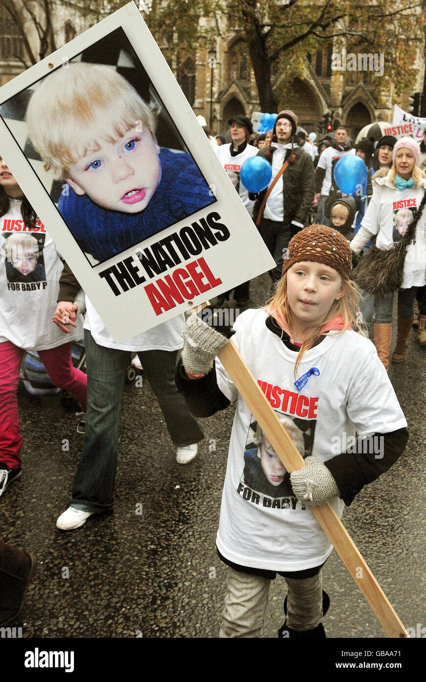 A young protester joins a large group of campaigners, some with their ...