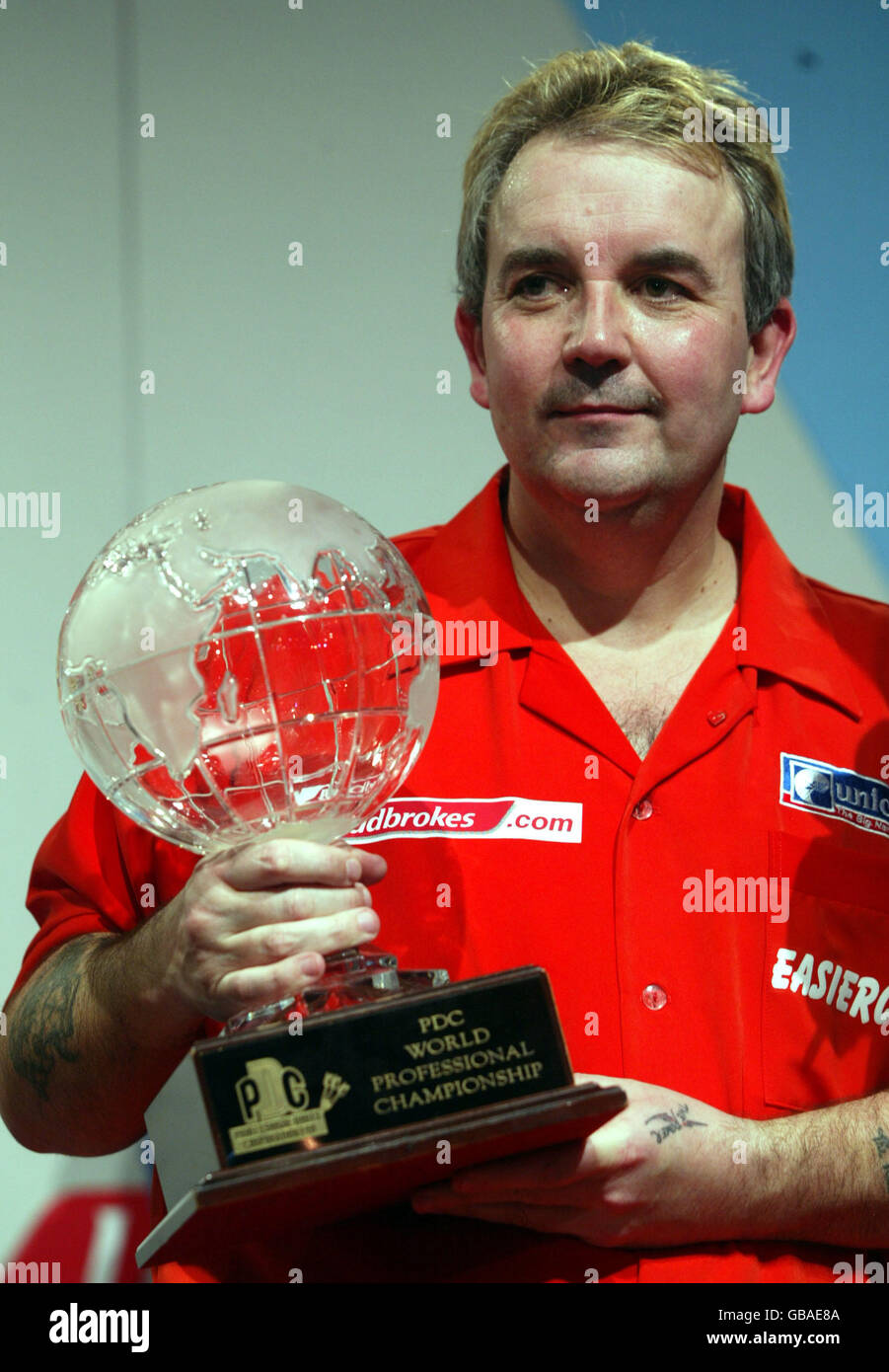 Phil Taylor with the trophy after winning the final for the eleventh ...