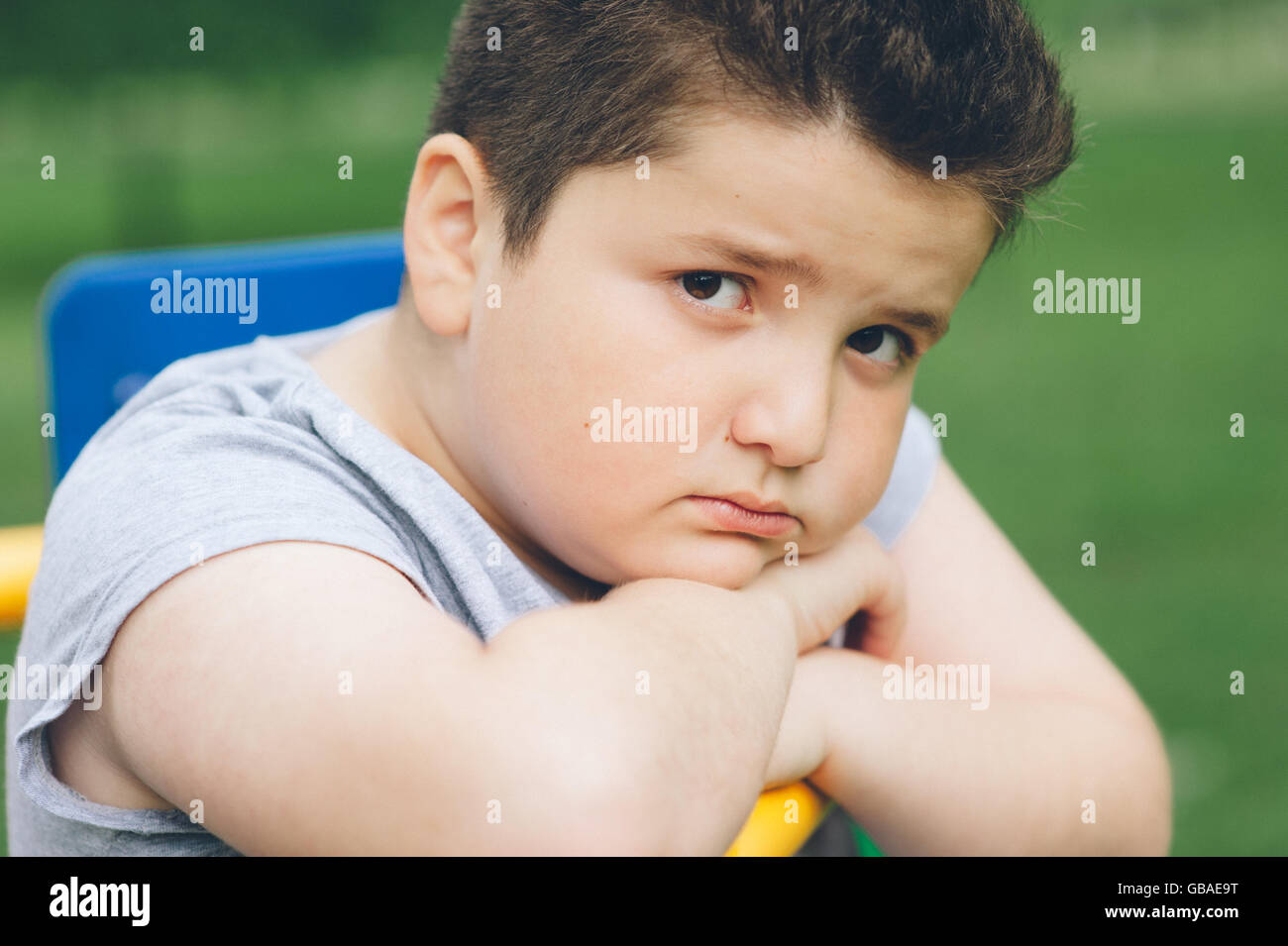 sad fat boy sitting on sports simulator Stock Photo - Alamy
