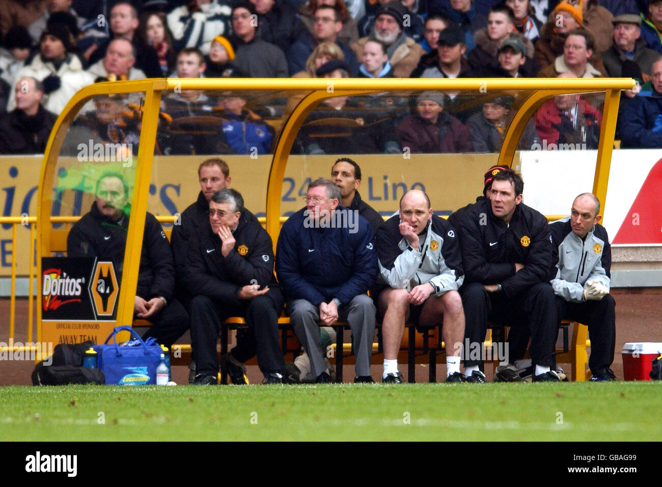 Manchester United's manager Sir Alex Ferguson (c) sits dejected on the ...