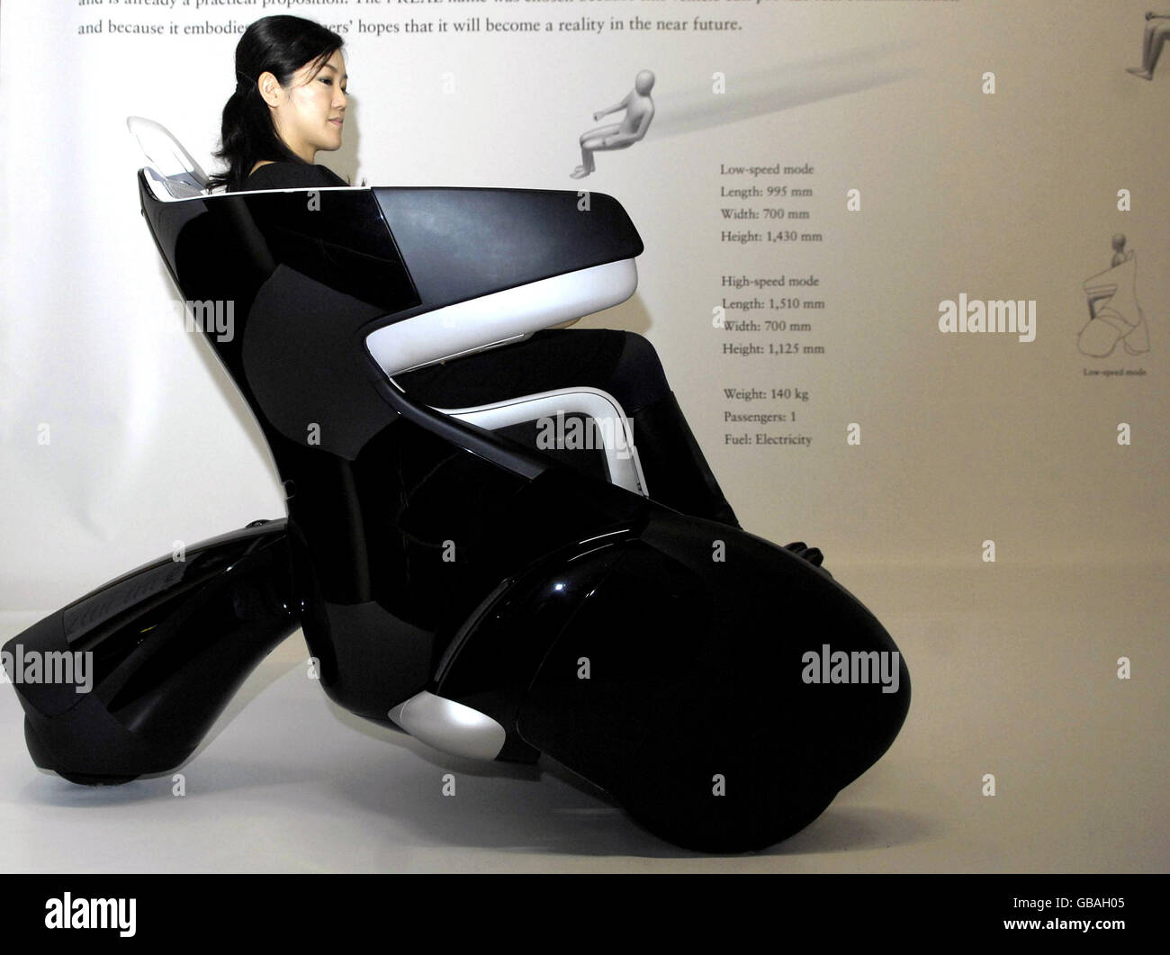 A girl sits in a Toyota i-REAL in the Science Museum in London. The ...