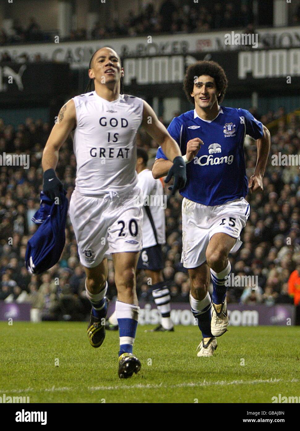 Everton's Steven Pienaar (l) celebrates with a "God is Great" shirt ...
