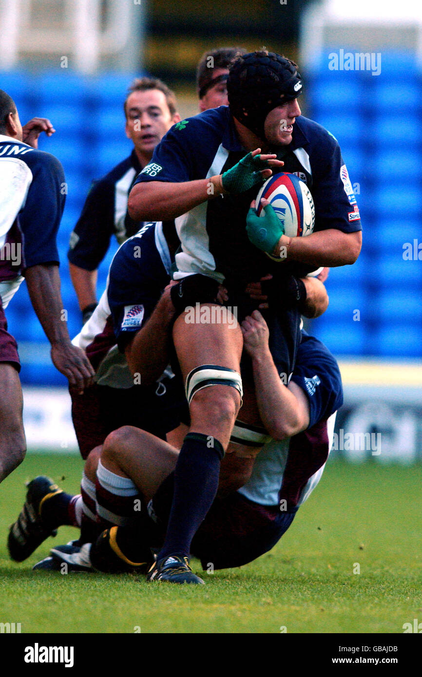 London Irish's Kieran Roche is brought down by the Rotherham defence ...