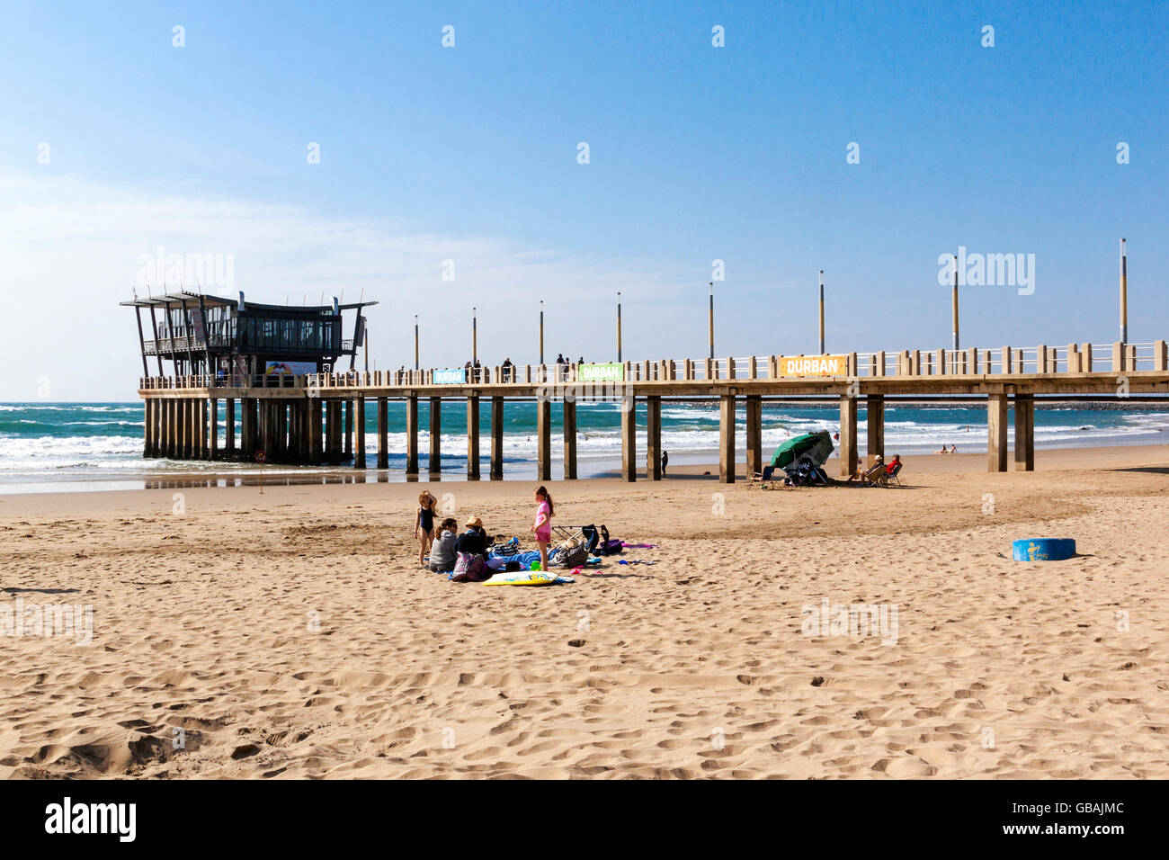 People and Vetchs pier against sea and skyline on Addington beach Stock ...