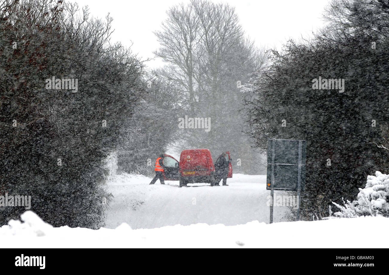 Postmen struggle in heavy snow in Castleside, County Durham Stock Photo ...