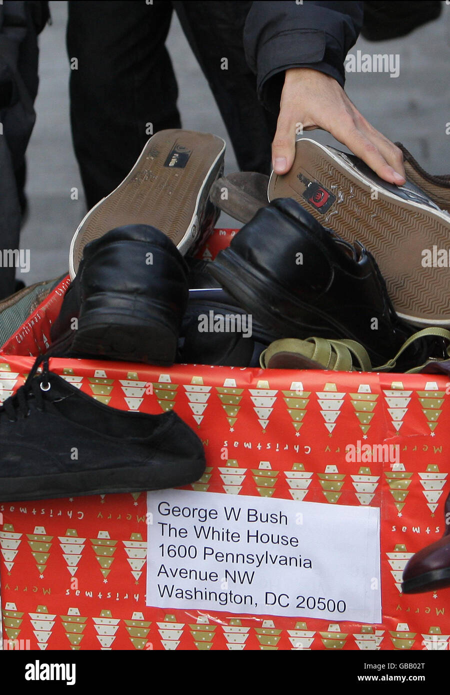 A protester adds a shoe to a box addressed to US President George Bush ...