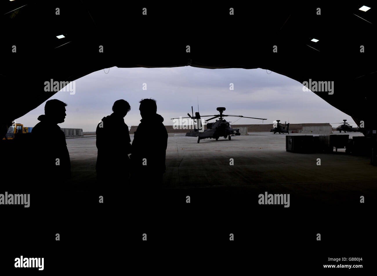 Apache helicopters are pictured resting on the flight line of 645 ...