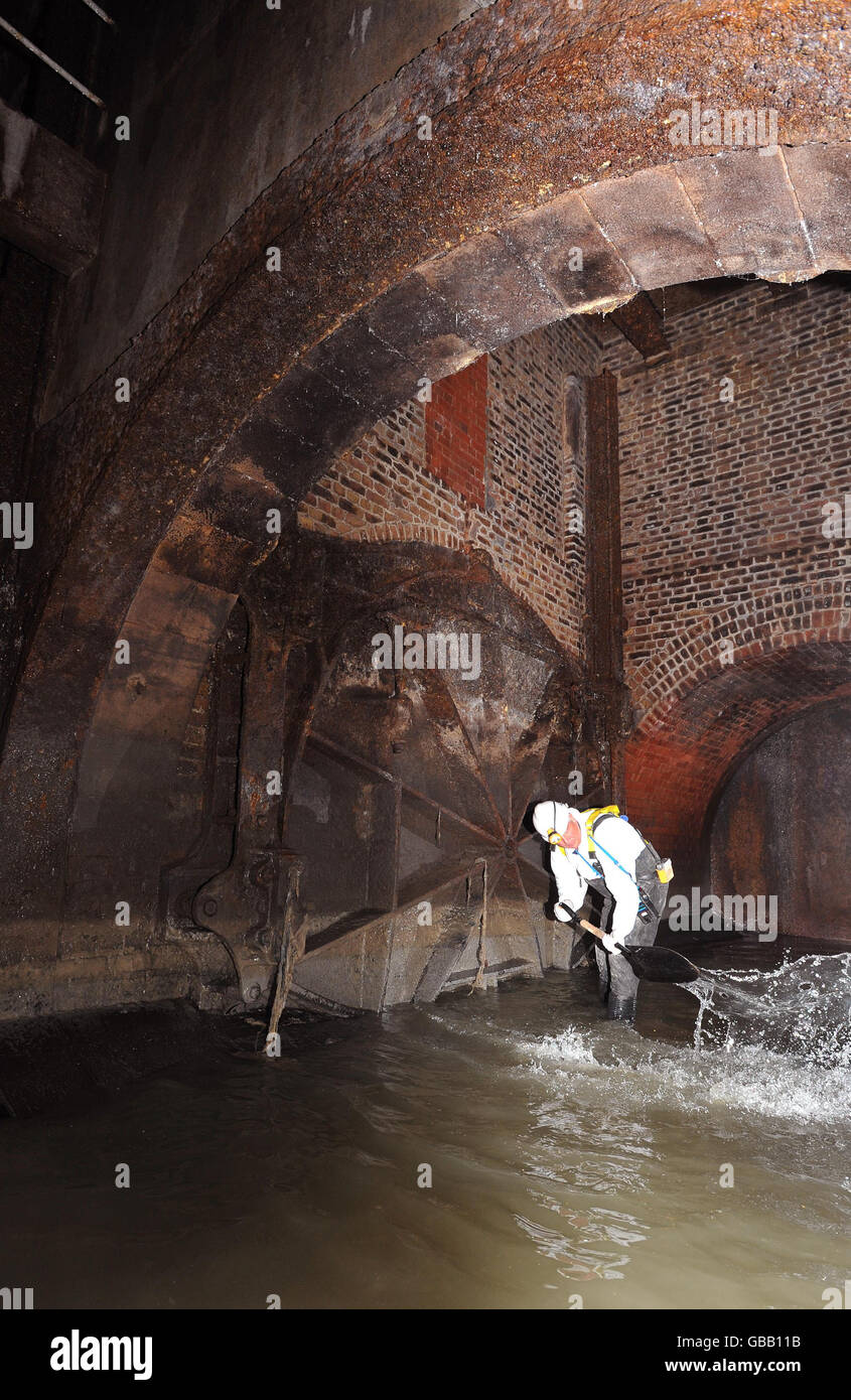 Rob Smith a 'flusher' with Thames Water clears away a mixture of water ...