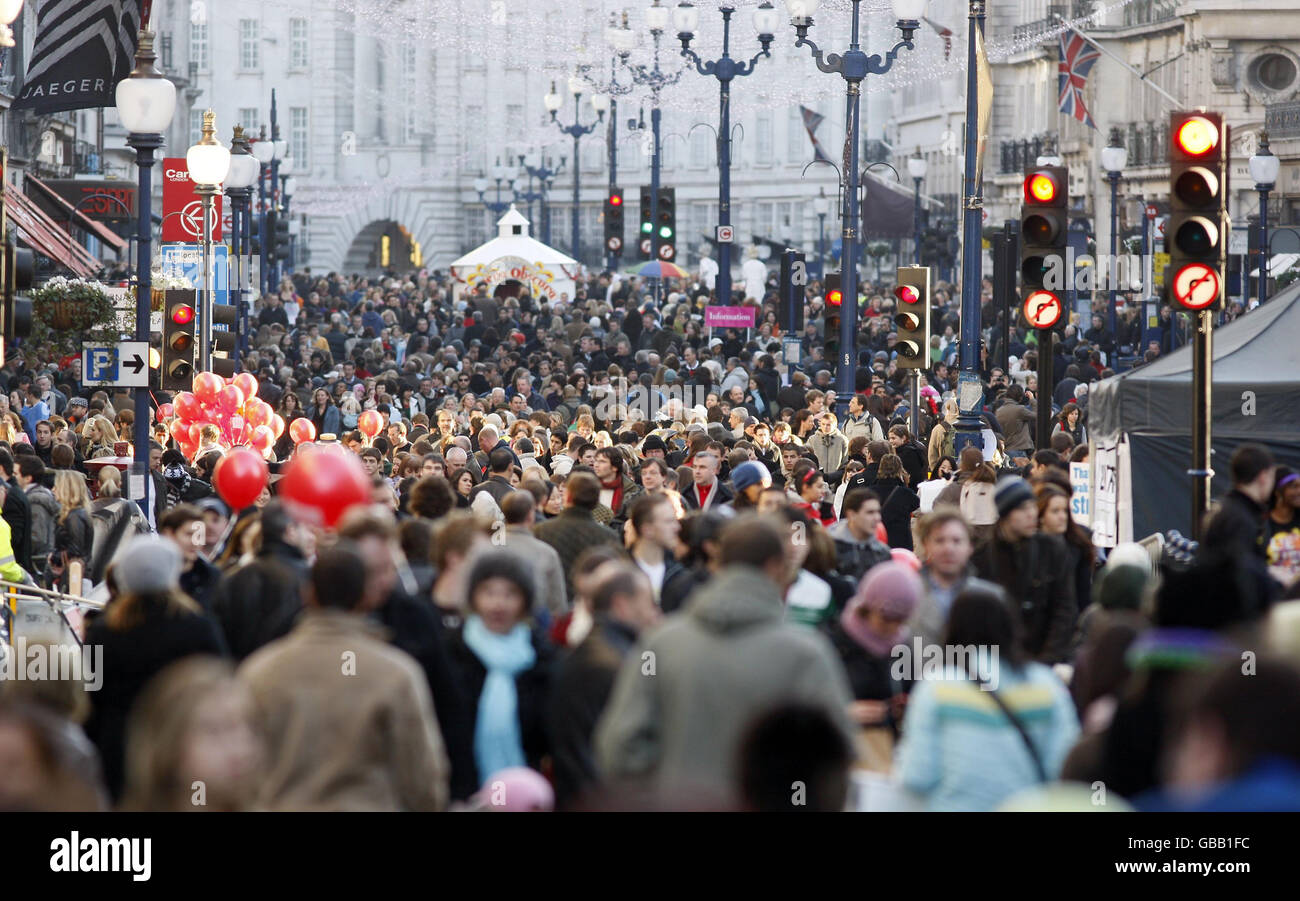 A huge crowd of Christmas shoppers block the pavements and the road, as ...