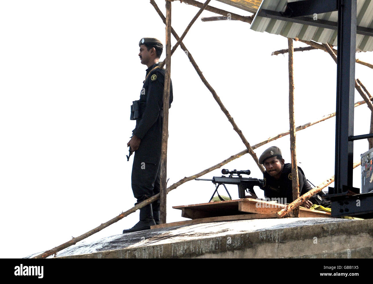 A sniper is seen on the roof of the stadium during the First Test Match ...