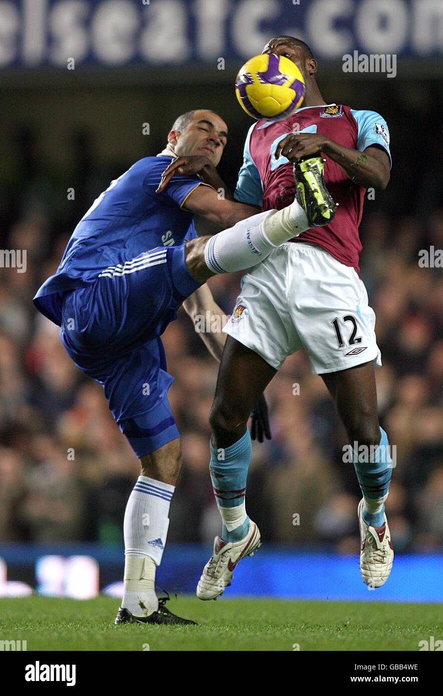 Chelsea's Alex (left) and West Ham United's Carlton Cole battle for the ...