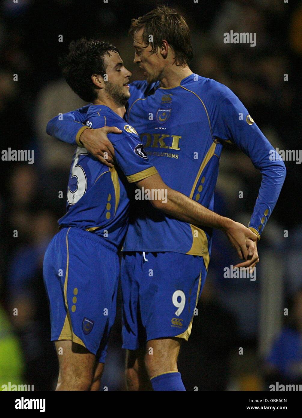 Portsmouth's Marc Wilson runs to congratulate team mate Peter Crouch ...
