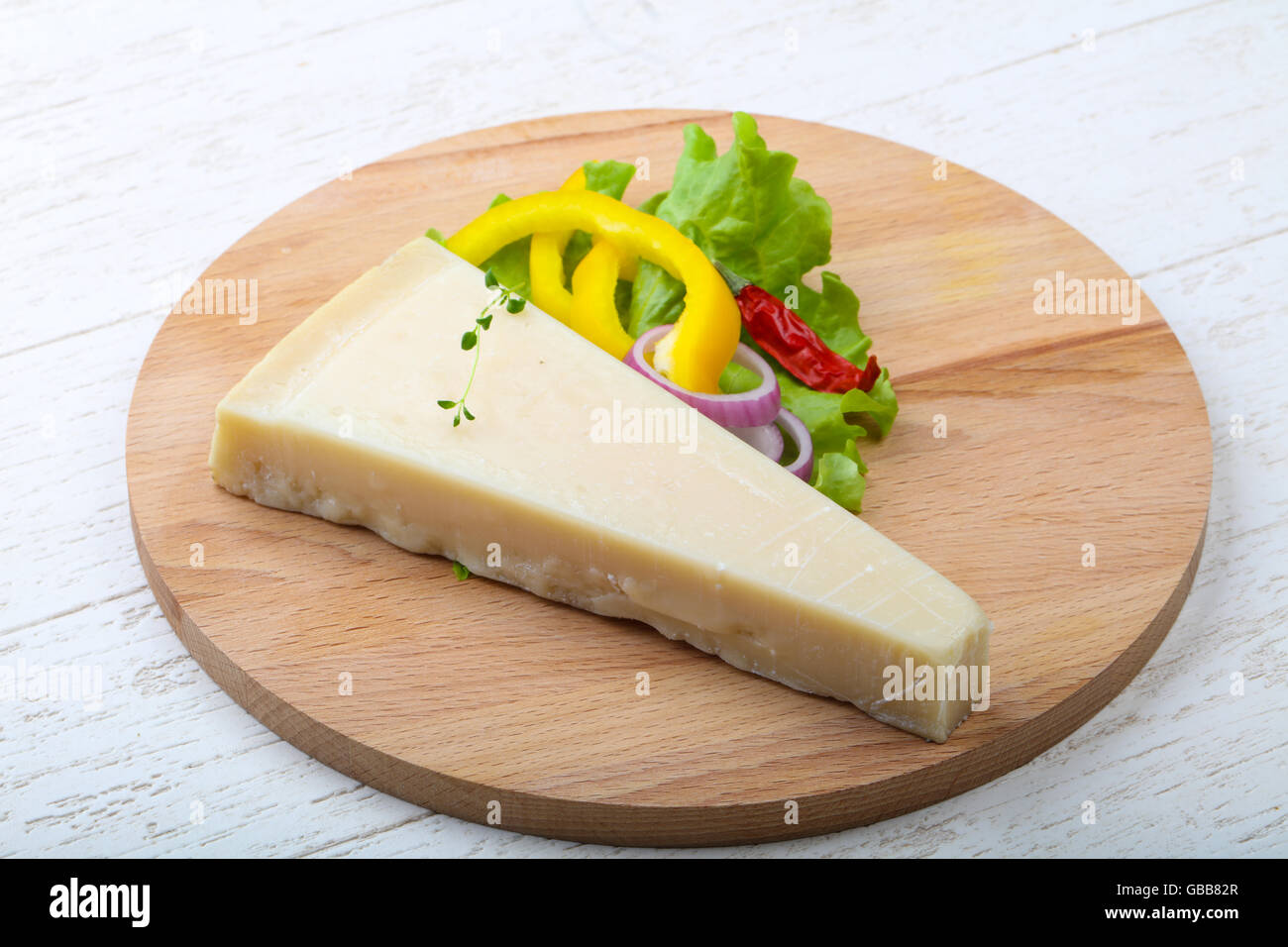 Parmesan cheese triangle on the wood background Stock Photo - Alamy