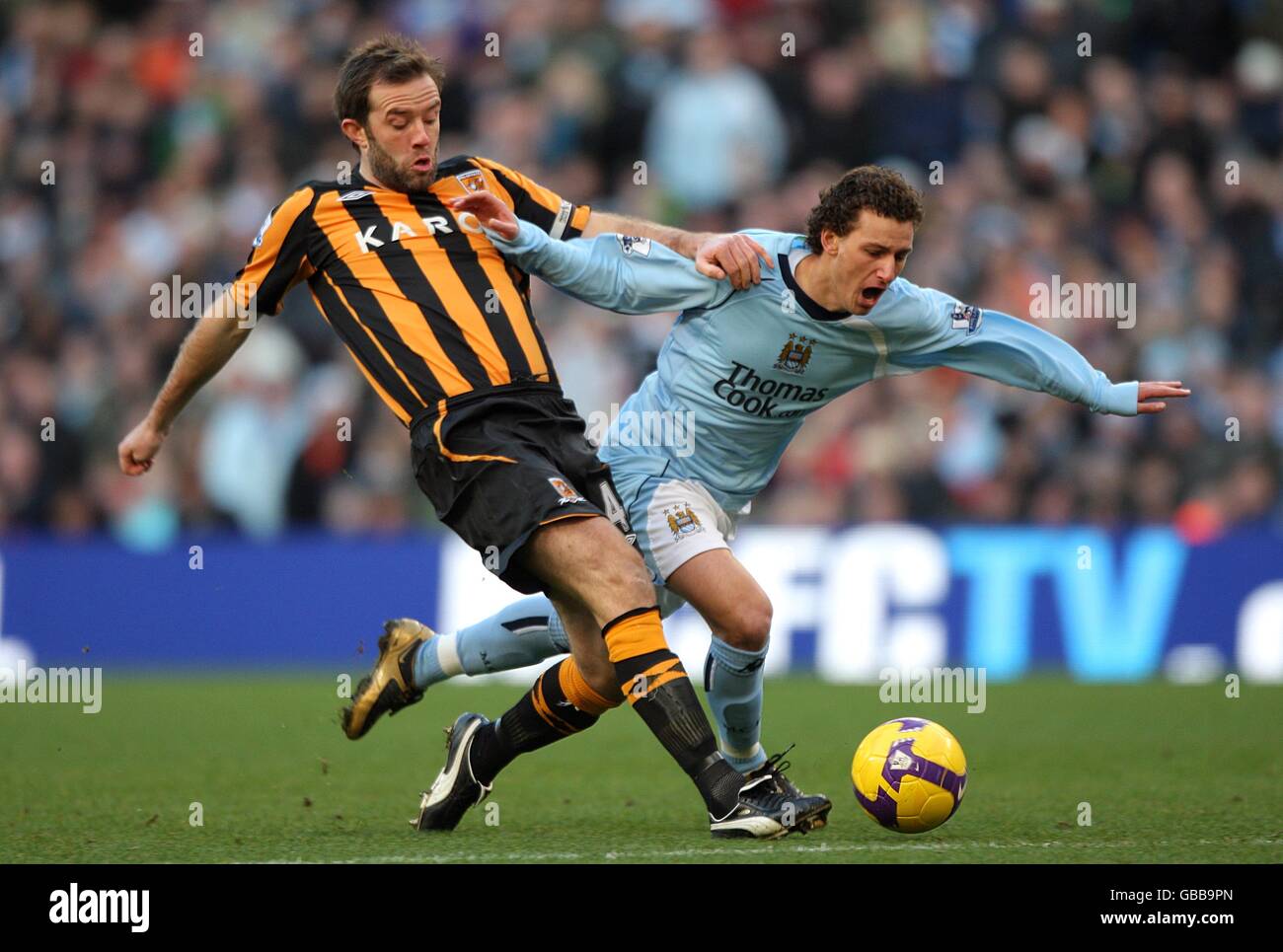 Hull City's Ian Ashbee (left) and Manchester City's Blumer Elano battle ...