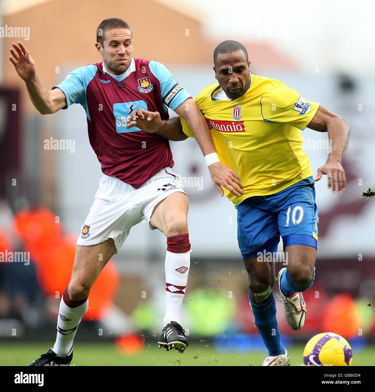 West Ham United's Matthew Upson (l) and Stoke City's Ricardo Fuller ...
