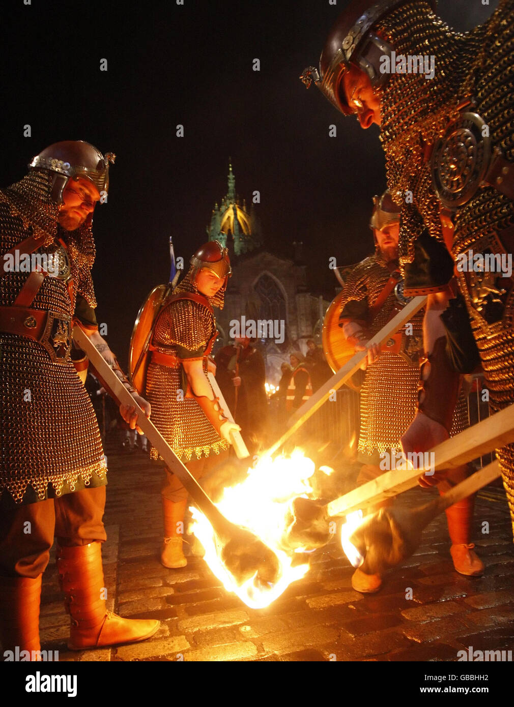 Vikings light their torches ahead of the torchlight parade as part of ...