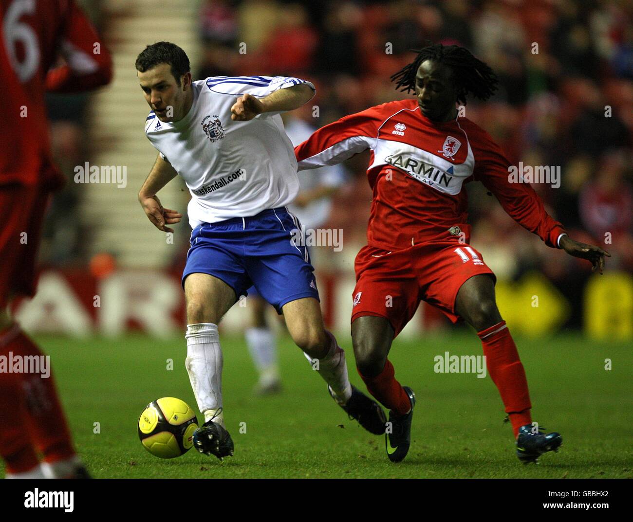Middlesbrough's Marvin Emnes and Barrow's Luke Joyce (left) battle for ...