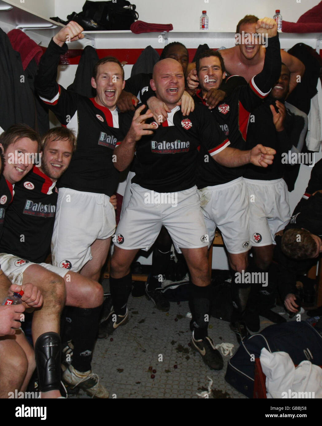 Kettering Town captain Guy Branston (centre) leads the celebrations ...