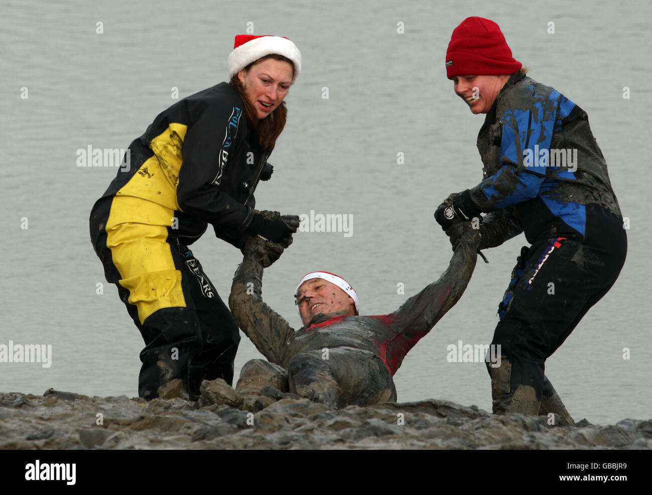A competitor gets a helping hand during the Maldon Mud Race, Maldon ...
