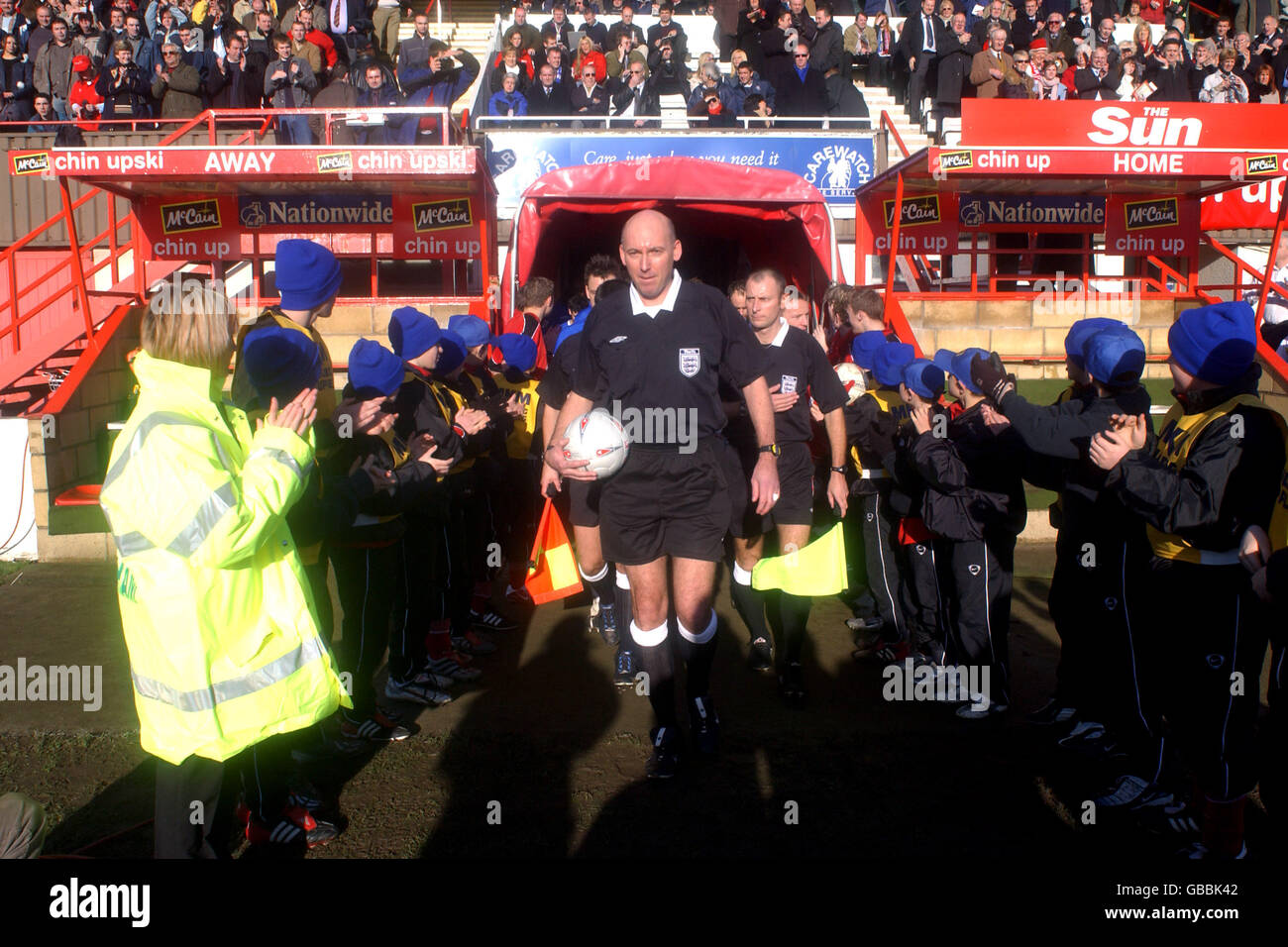 Referee barry knight leads the teams out onto the pitch hi-res stock ...