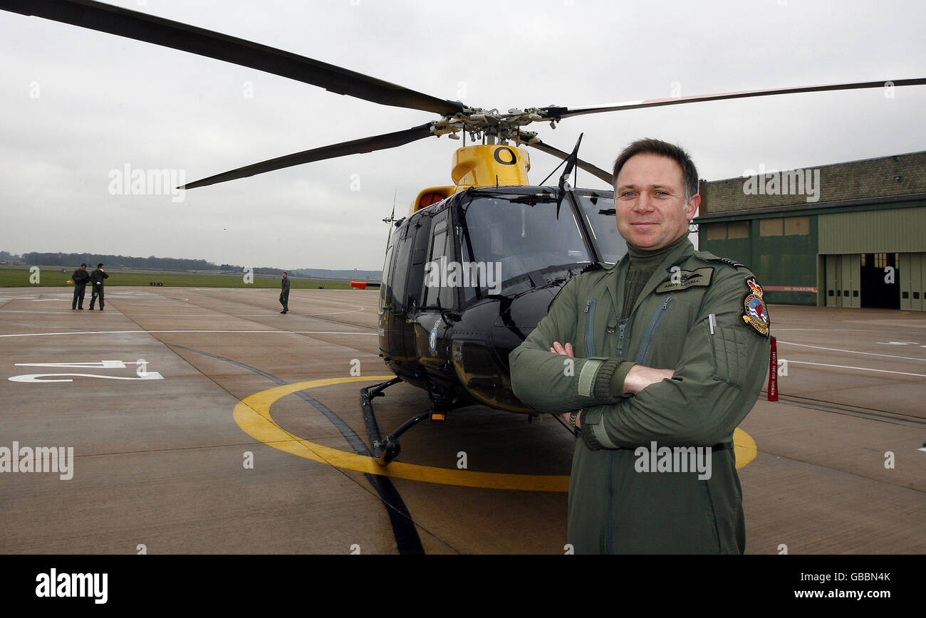 Wing Commander Andy Lovell beside a Griffin Helicopter at RAF Shawbury ...