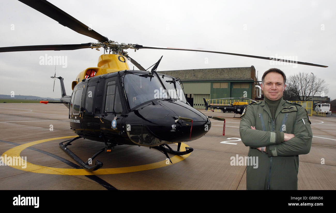 Wing Commander Andy Lovell beside a Griffin Helicopter at RAF Shawbury ...