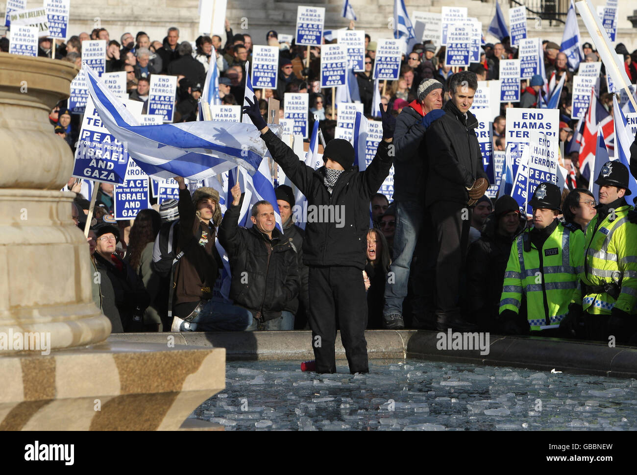A pro-Palestinian protester gestures as he stands in front of pro ...