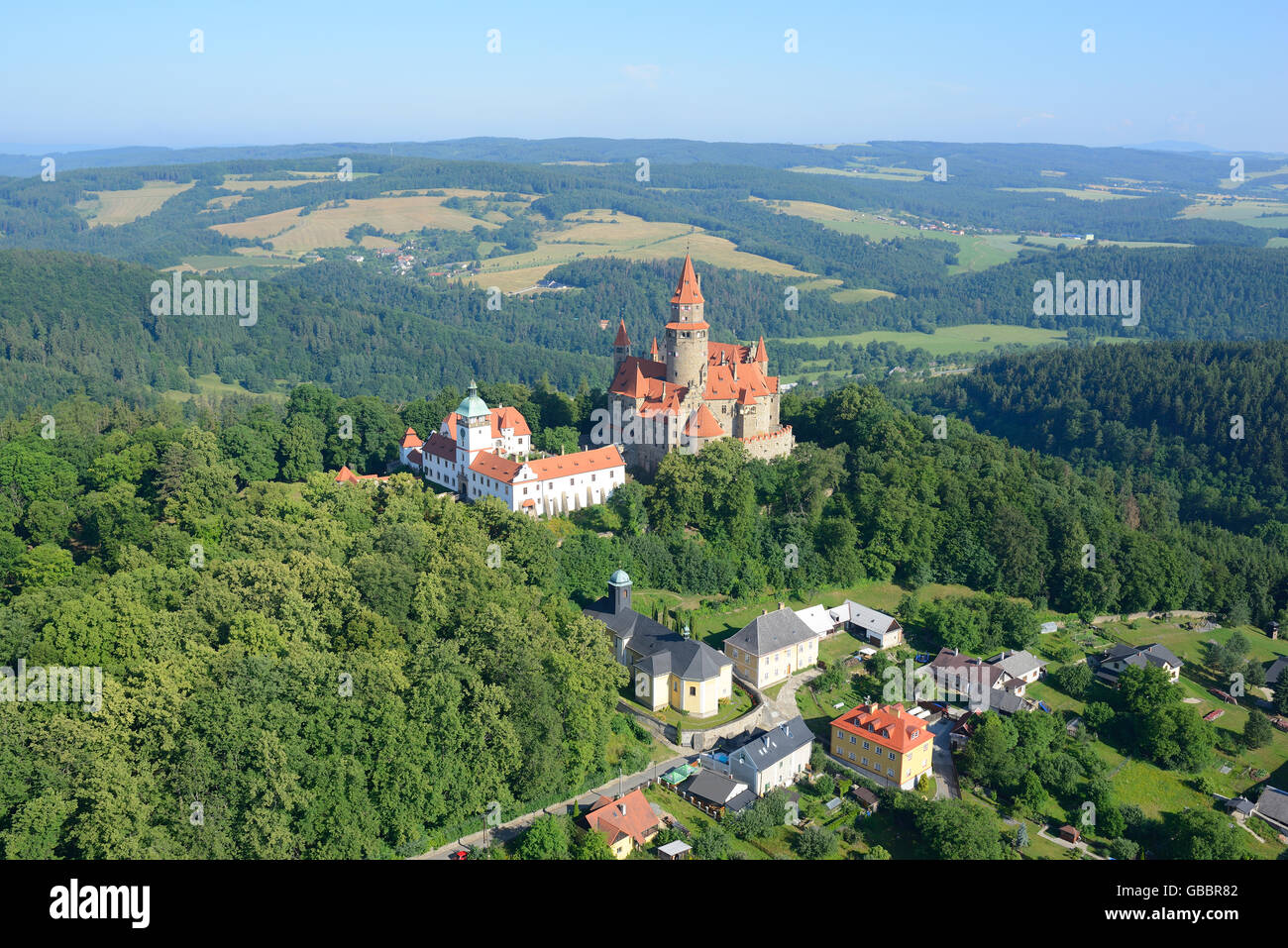 AERIAL VIEW. Medieval castle in a landscape of green rolling hills ...