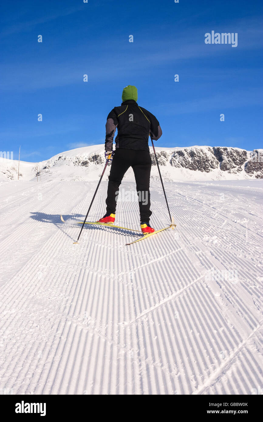 Ski athlete climbing steep hill with herring bone technique Stock Photo ...