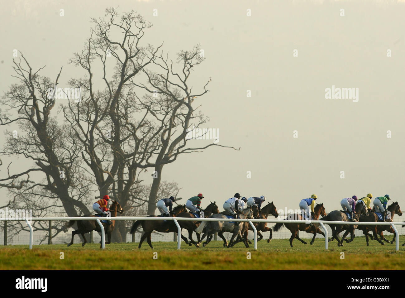 Horses and riders make their way around taunton racecourse hi-res stock ...