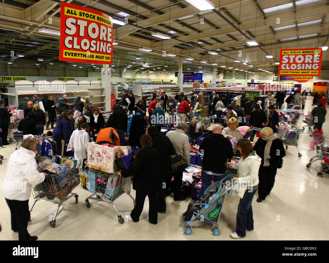 Shoppers look for discounted items at a Woolworths store in Edinburgh ...