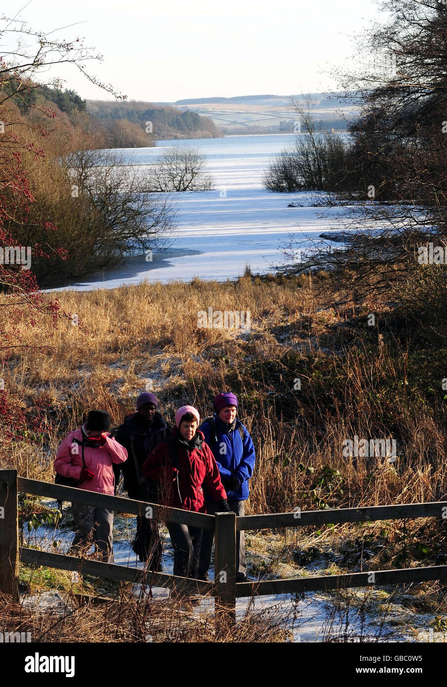 Walkers near the partially frozen Fewston Reservoir, near Harrogate ...