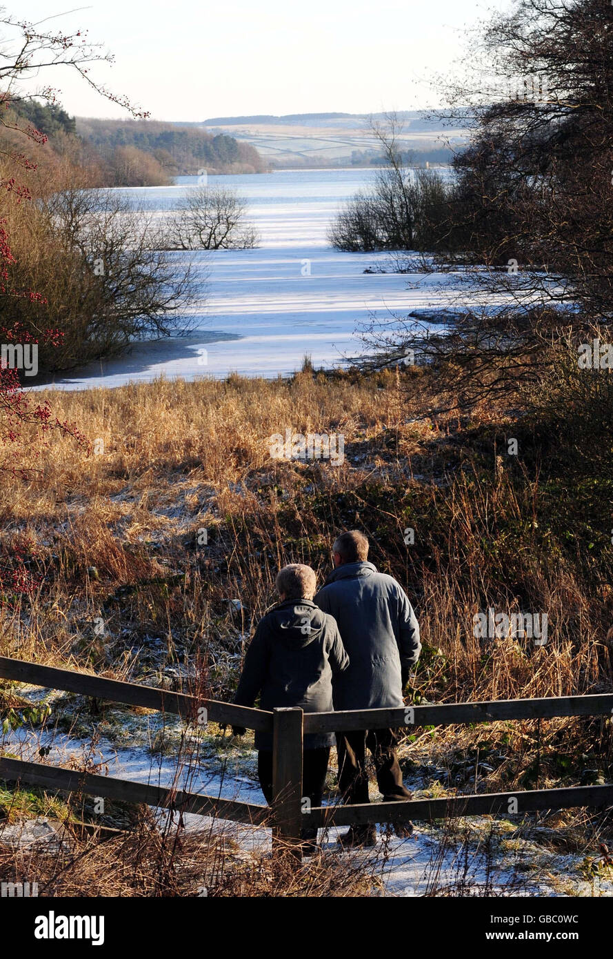 Walkers near the partially frozen Fewston Reservoir, near Harrogate ...