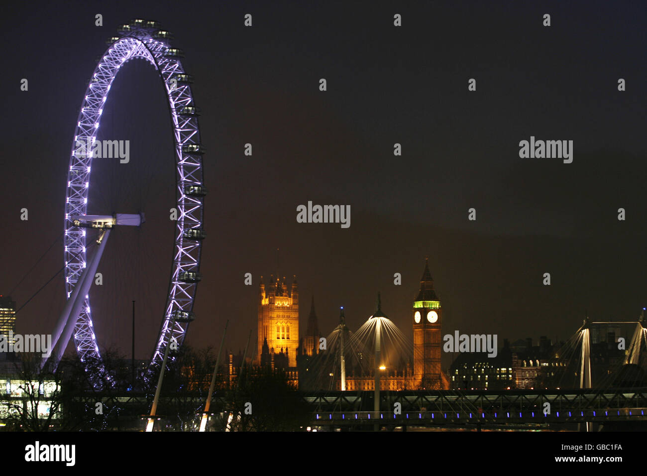London at night. London Eye and the Houses of Parliament viewed from ...