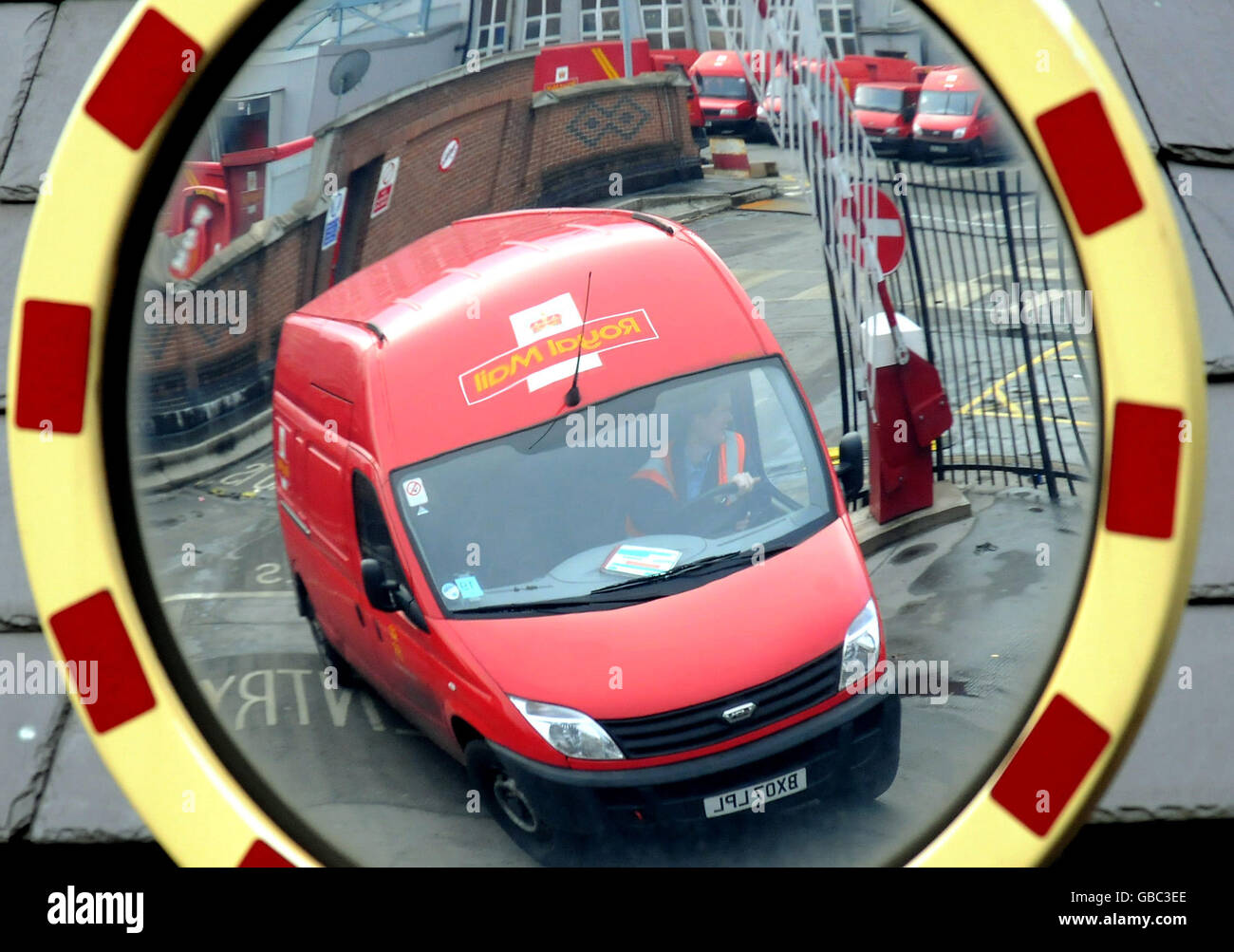 A postal van is reflected in a mirror as it leaves the Royal Mail Mount ...