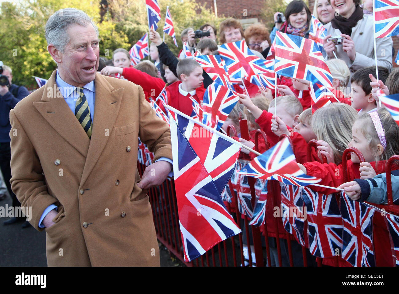 The Prince of Wales smiles as he meets school children in the village ...