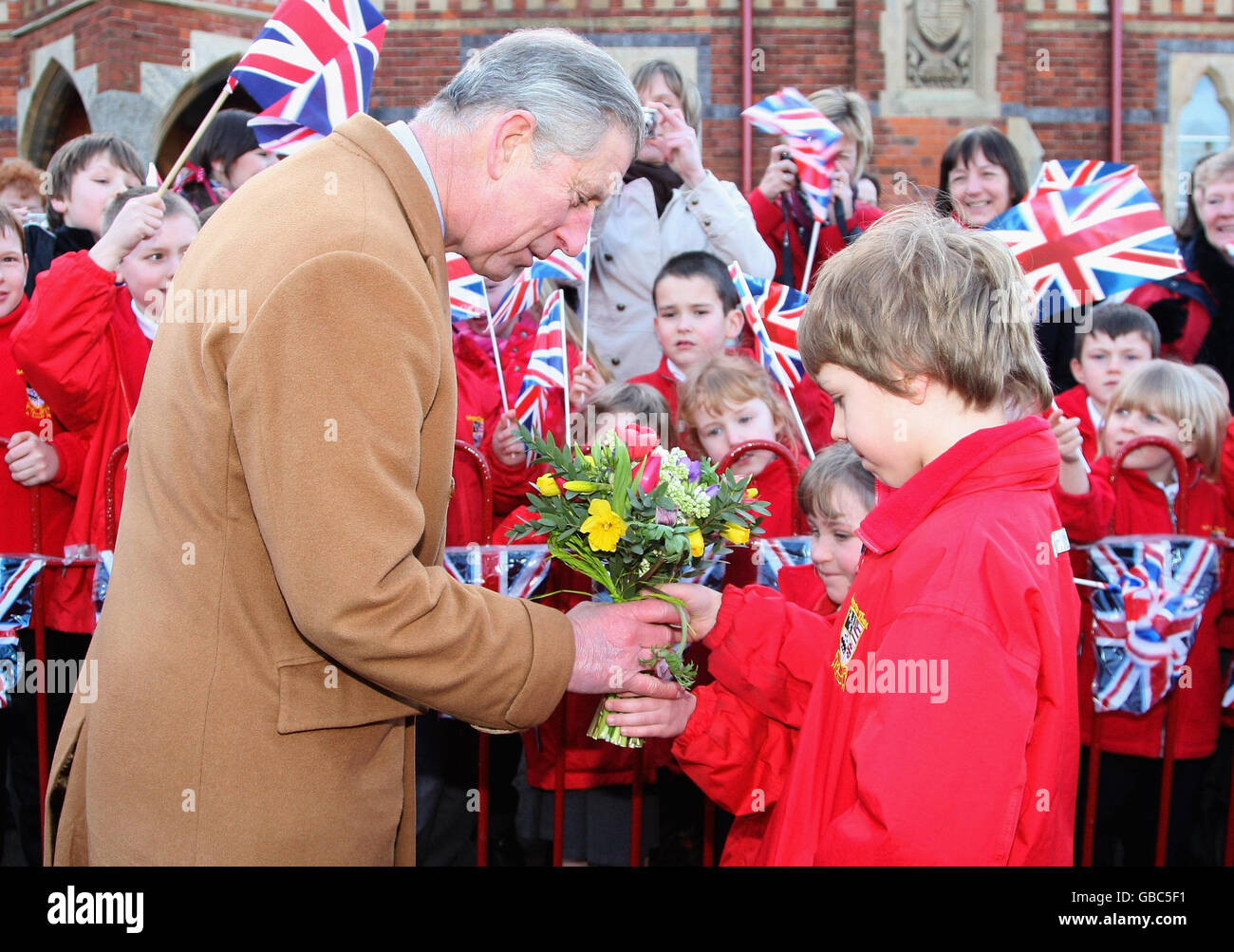 The Prince of Wales smiles as he meets school children in the village ...