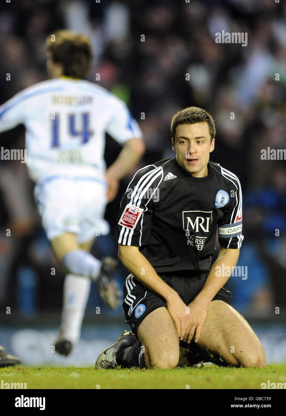 Peterborough United's captain Craig Morgan kneels dejected after Leeds ...